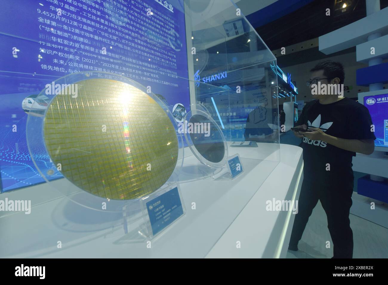 SHANGHAI, CHINA - JUNE 12, 2024 - Visitors view a 12-inch wafer ...
