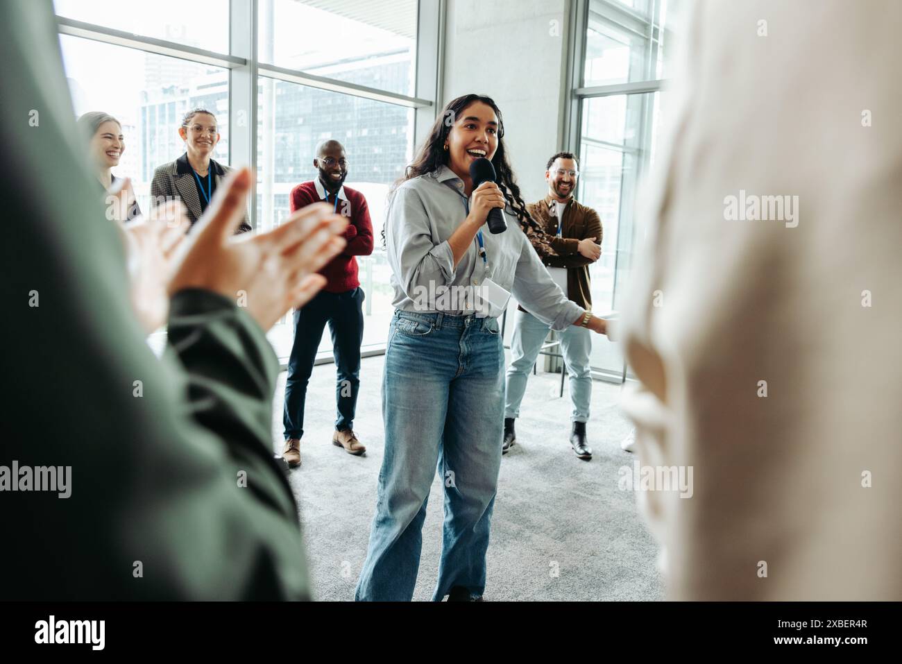 Young businesswoman presenting to a group of colleagues in a modern ...