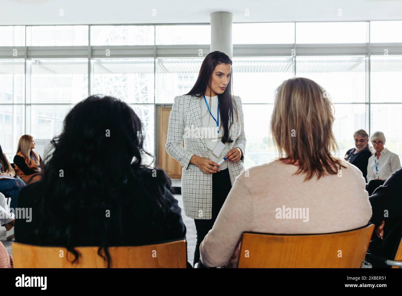 Confident businesswoman leading a discussion with colleagues in a ...