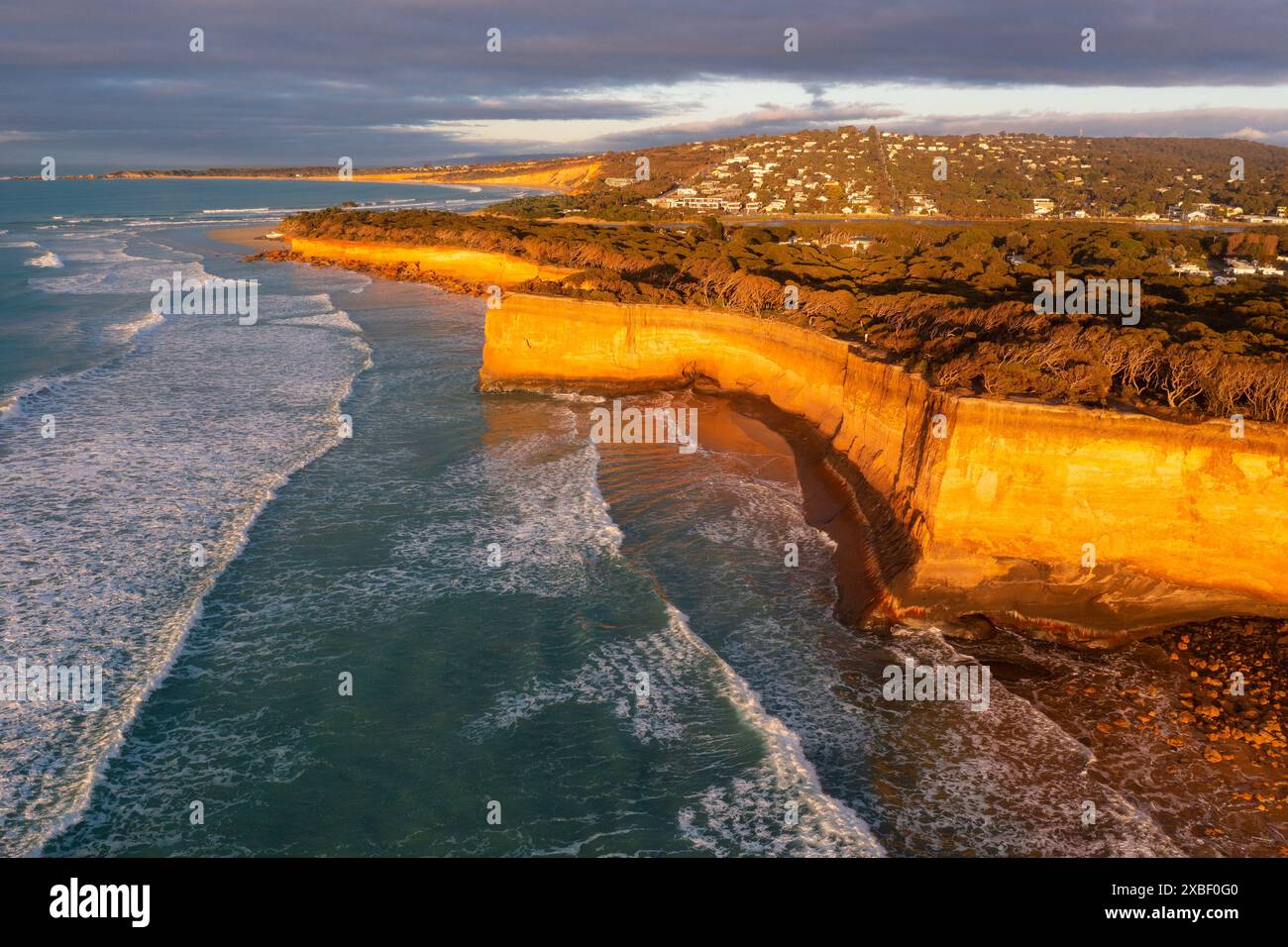 Aerial view of high coastal cliffs in dramatic morning light at ...