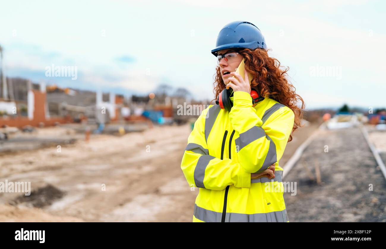 redhead female site engineer surveyor working with theodolite total ...