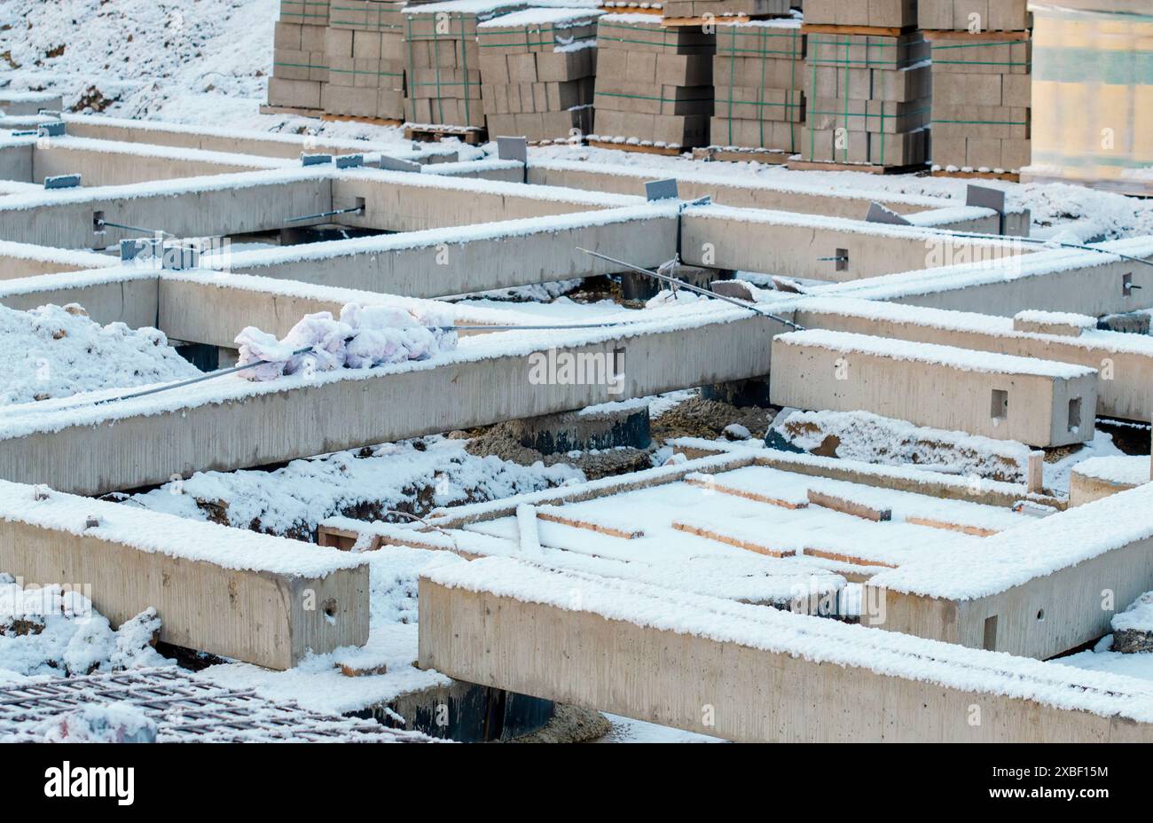 Concrete foundation for a new house in the wintertime under snow ...