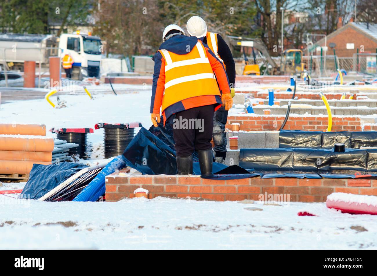 Waterproof installation at new house construction. Builders installing ...