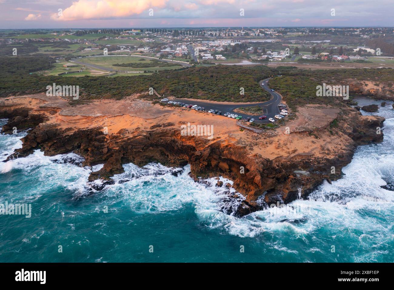 Aerial view of a coastal carpark lookout above rugged cliffs and ...