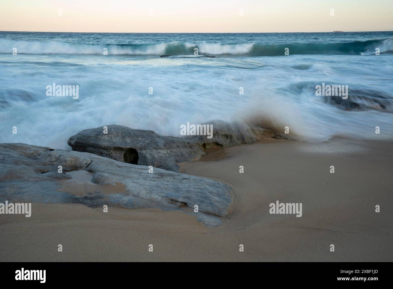 Slow motion waves breaking at sunset at the beach Stock Photo - Alamy