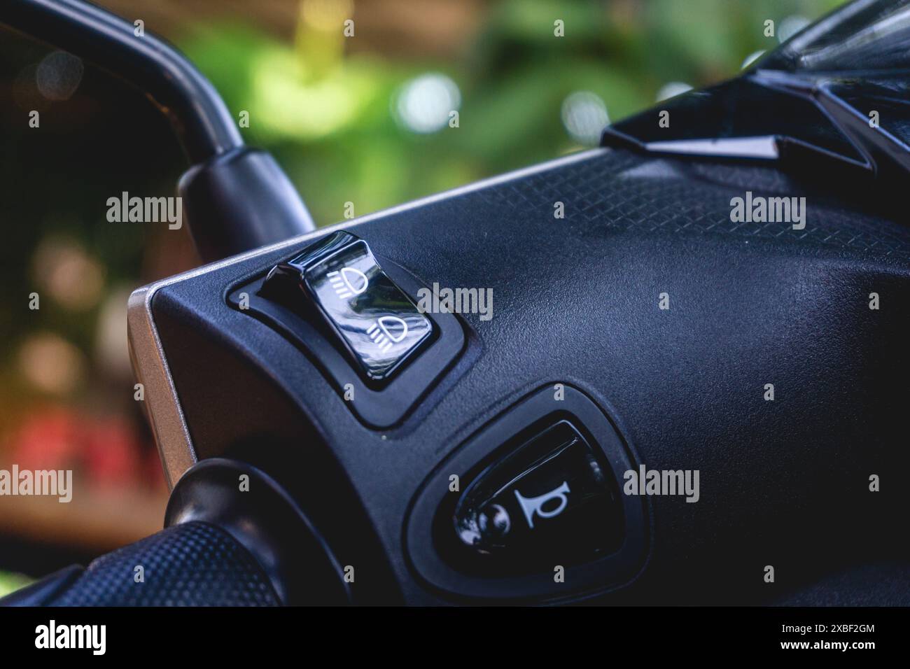 Close up image of motorcycle headlight, turn signal and horn buttons ...