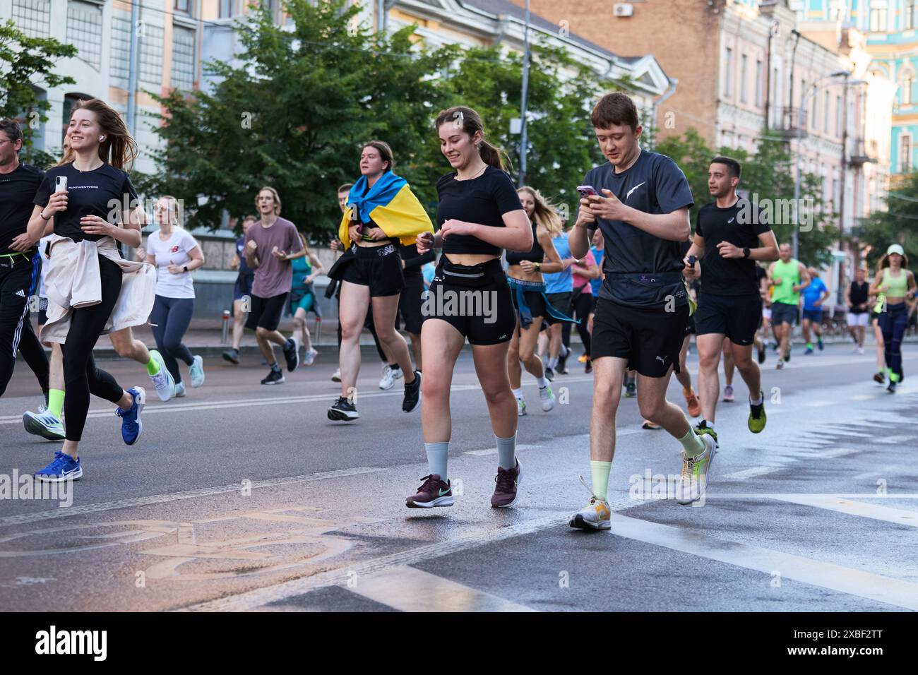 Large crowd of active and healthy people runs a marathon in urban ...