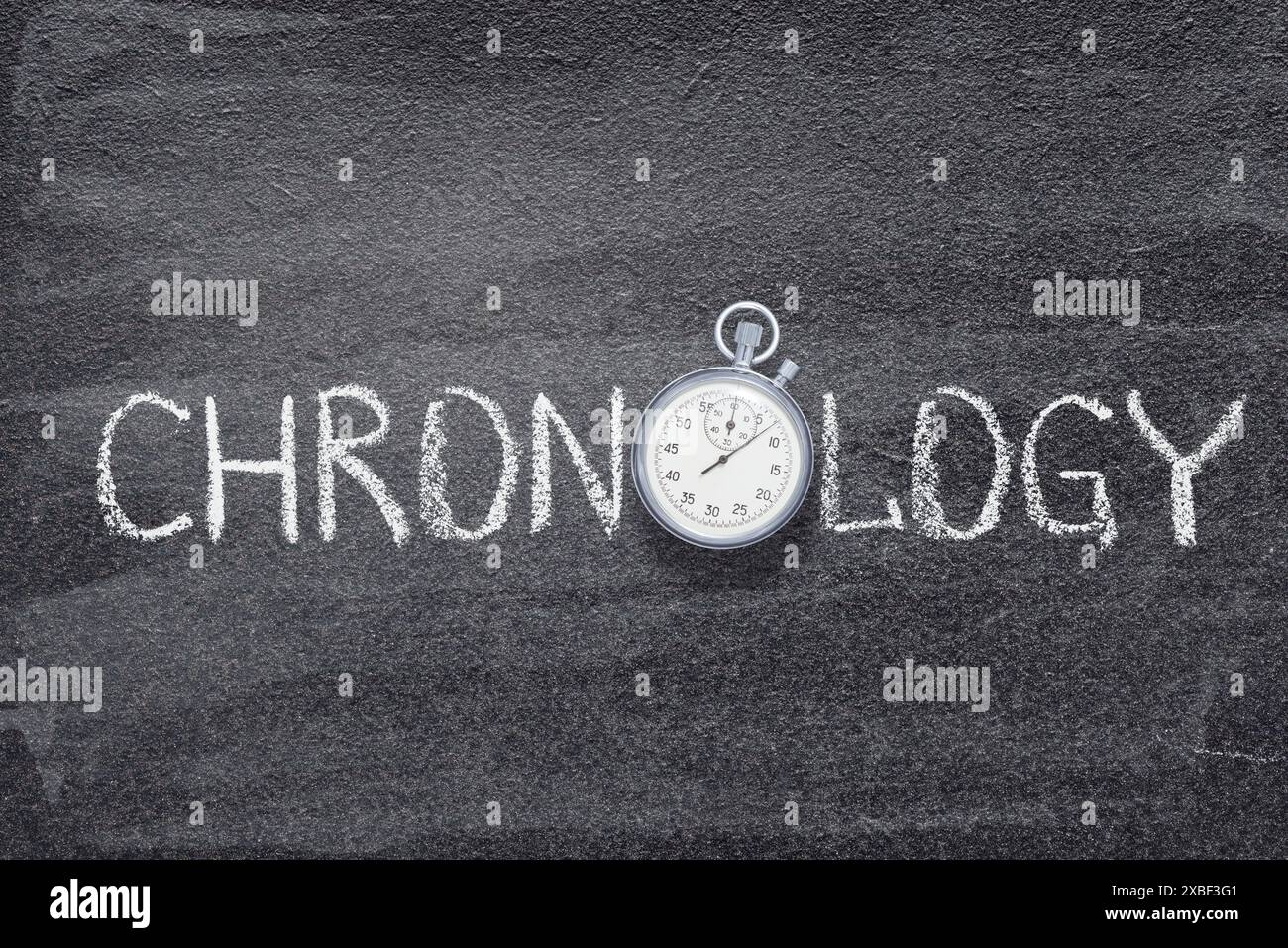 chronology word written on chalkboard with vintage precise stopwatch ...