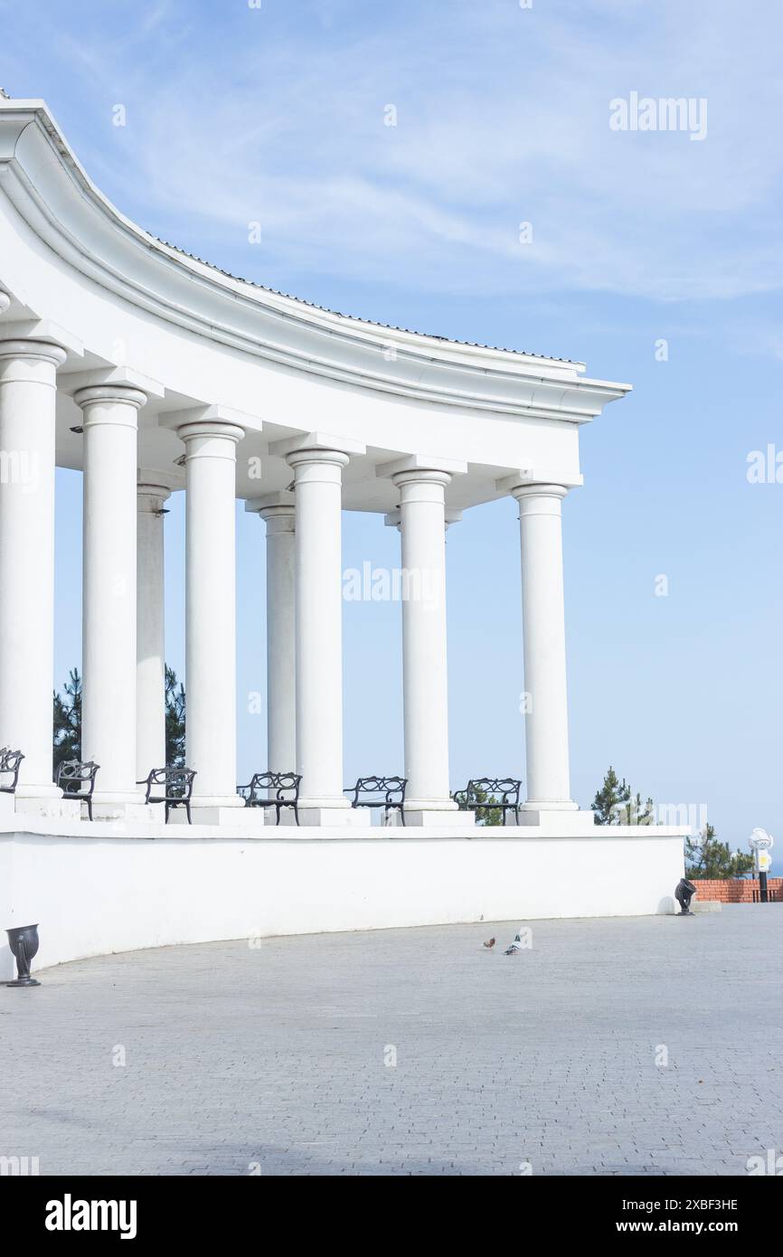 Seaside colonnade in Chornomorsk, Ukraine. White columns and arch on ...