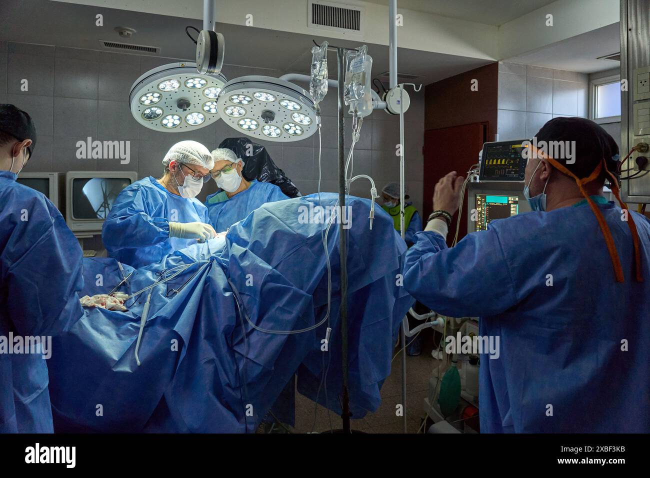 Surgical Team Performing Procedure in Operating Room Under Bright ...