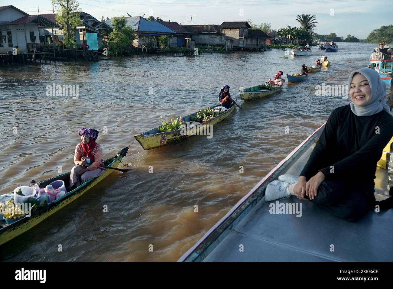 Banjar, Indonesia. 12th June, 2024. Vendors riding in klotok boats wait ...