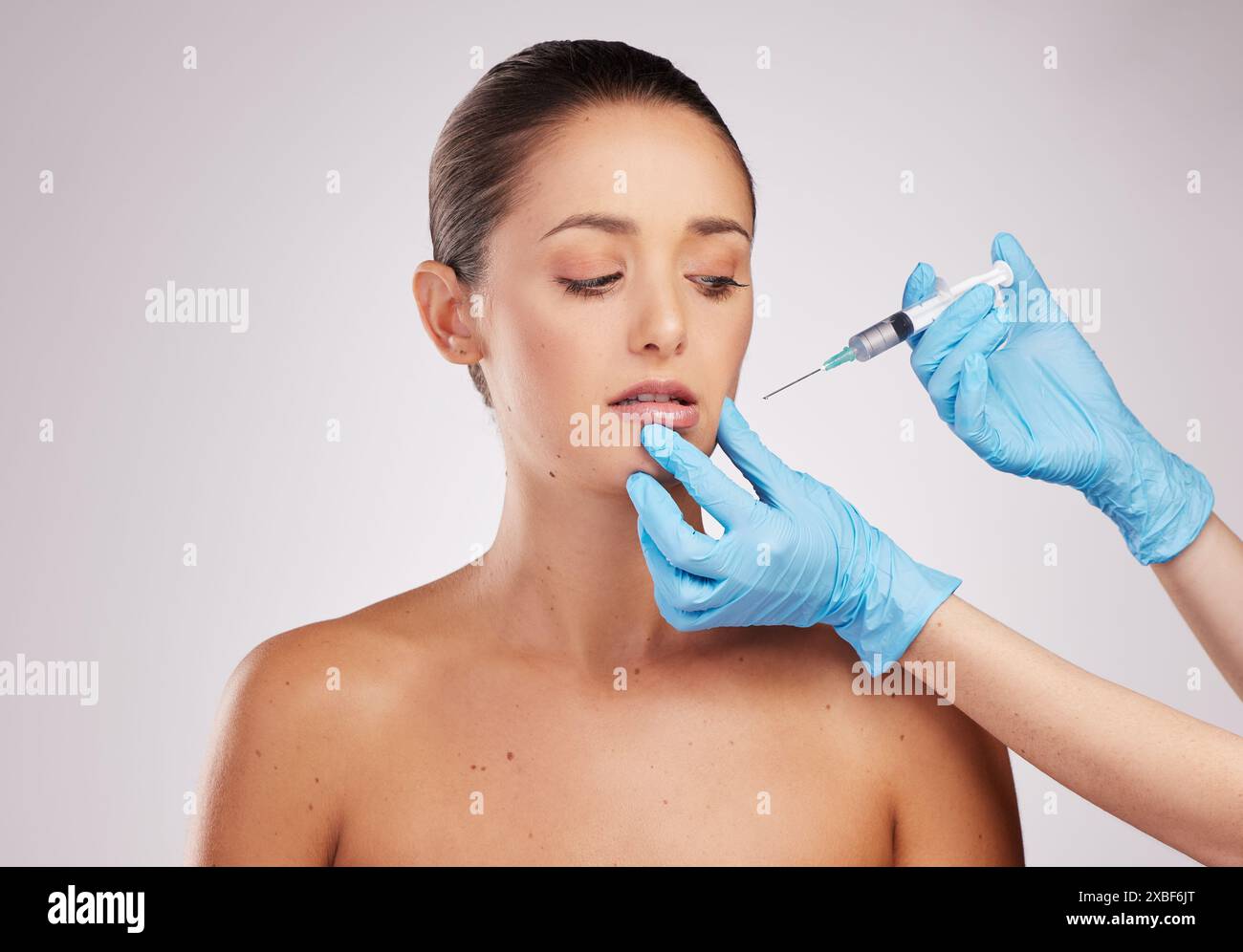 Woman, beauty and needle in hand for plastic surgery with facelift and ...