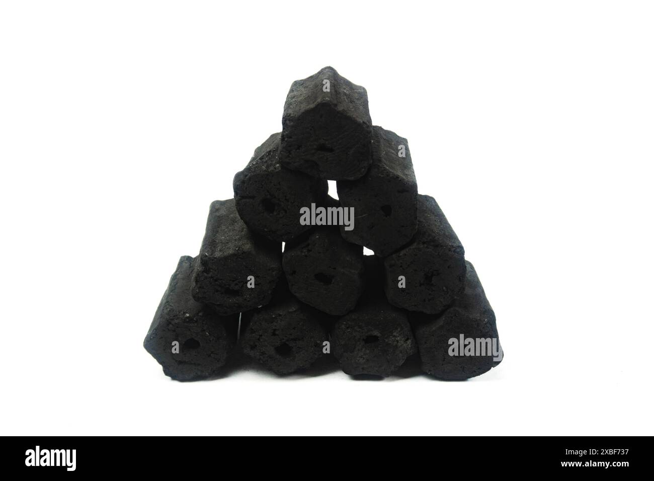 pile of hexagonal charcoal briquettes isolated on a white background ...