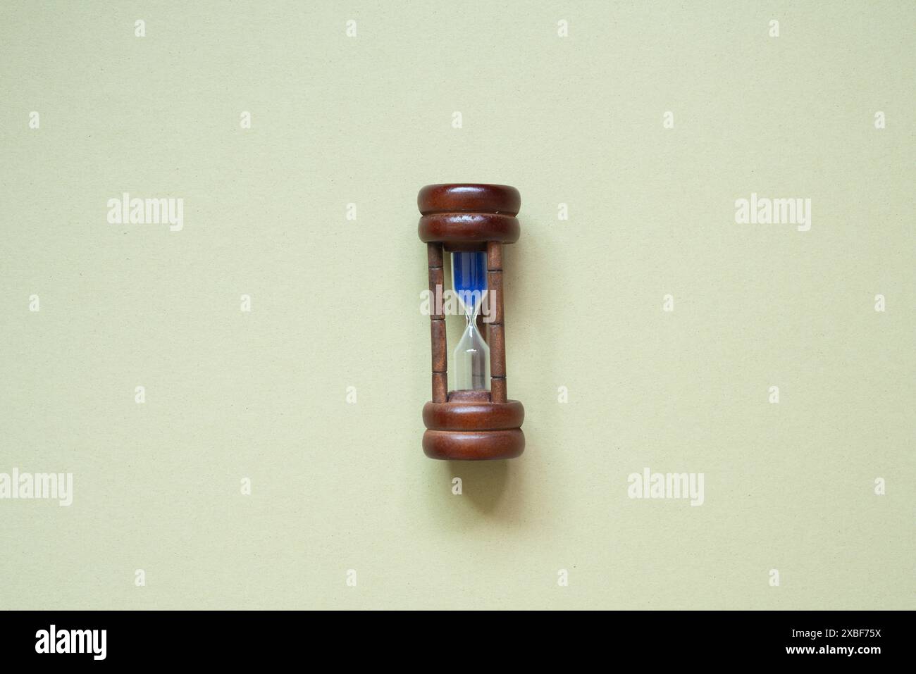 Wooden hourglass sandglass isolated on khaki background. top view Stock ...