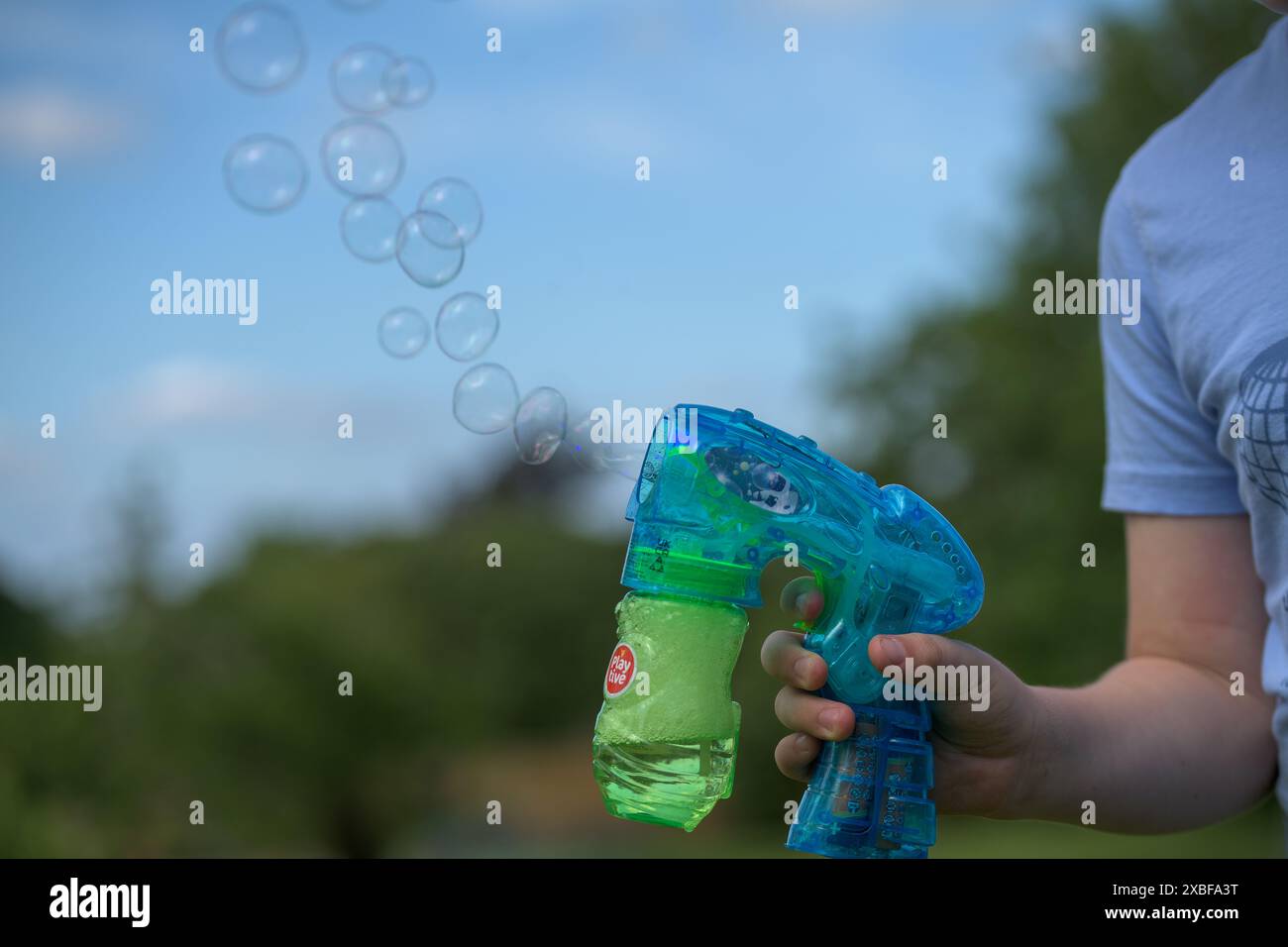 A stream of bubbles being fired from a bubble gun Stock Photo - Alamy