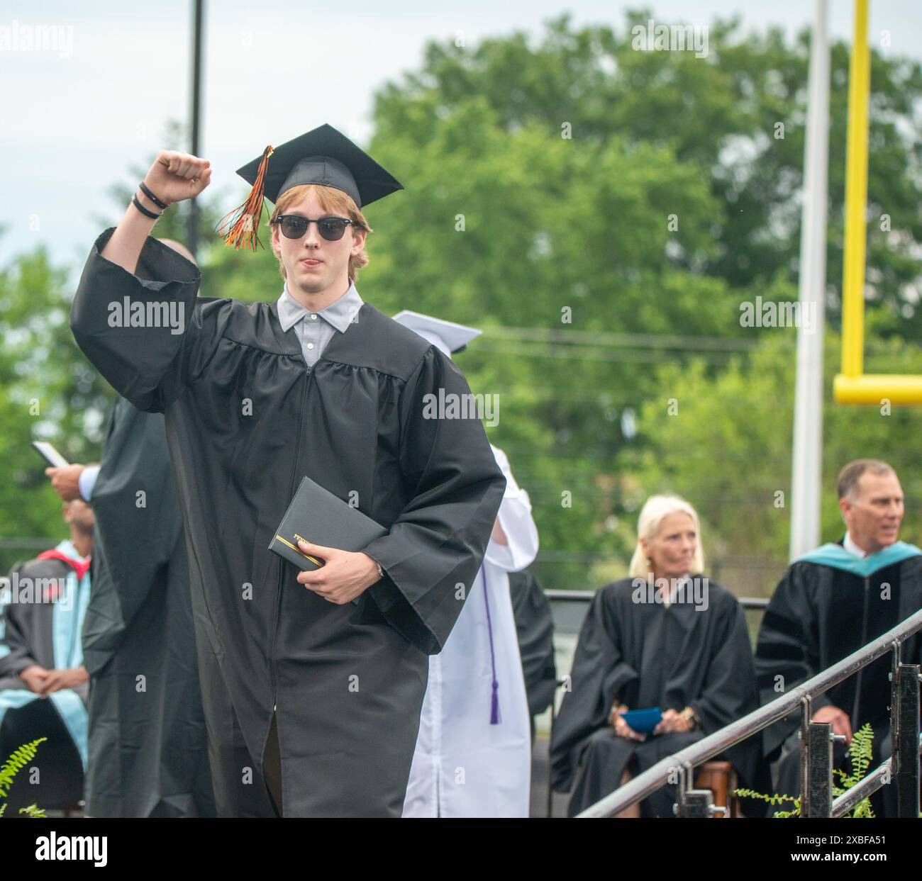 Graduates march into the school stadium to receive their diplomas ...
