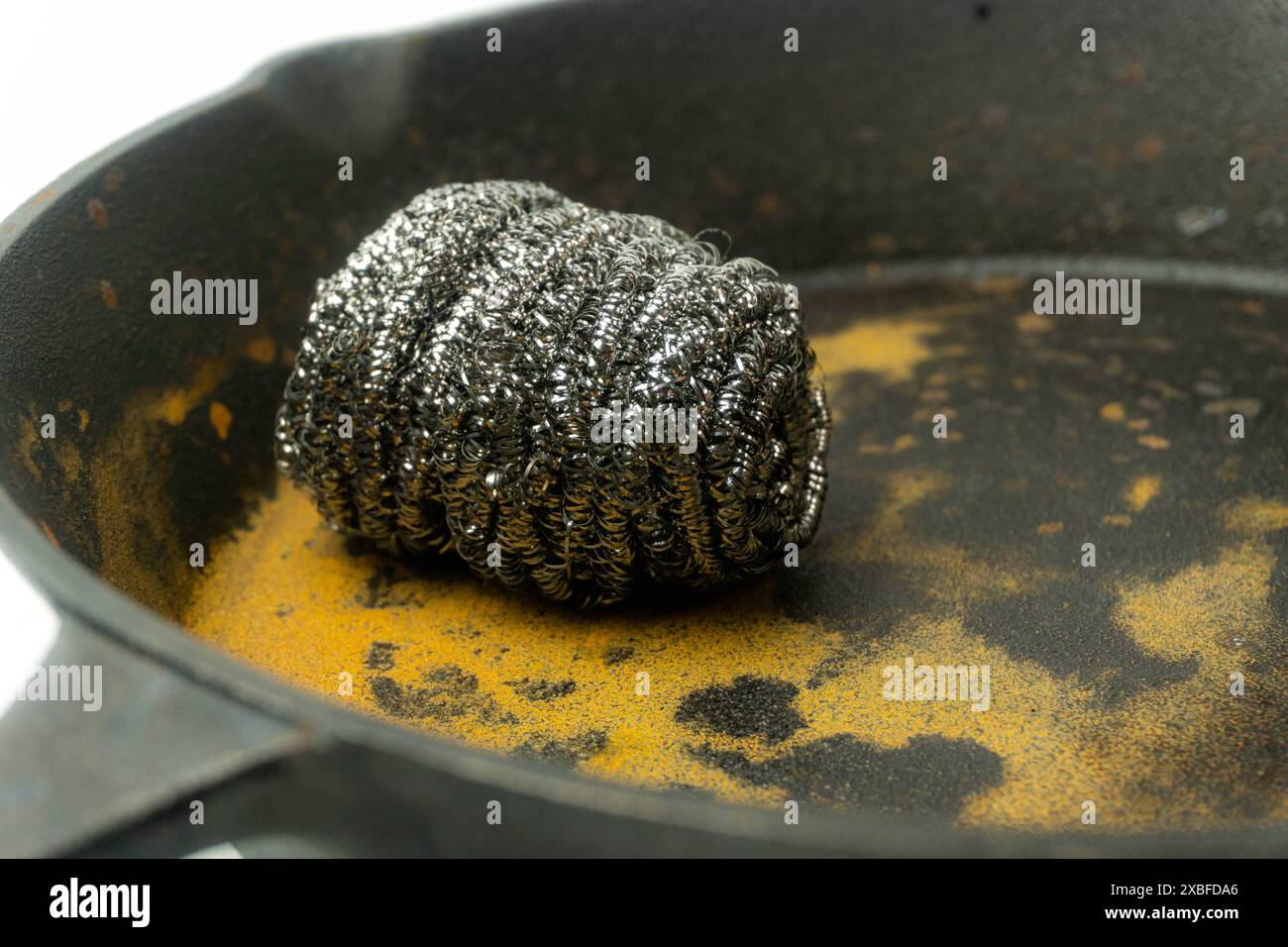 Steel wool scrubbers or stainless steel scrubbers on top of rusty cast ...