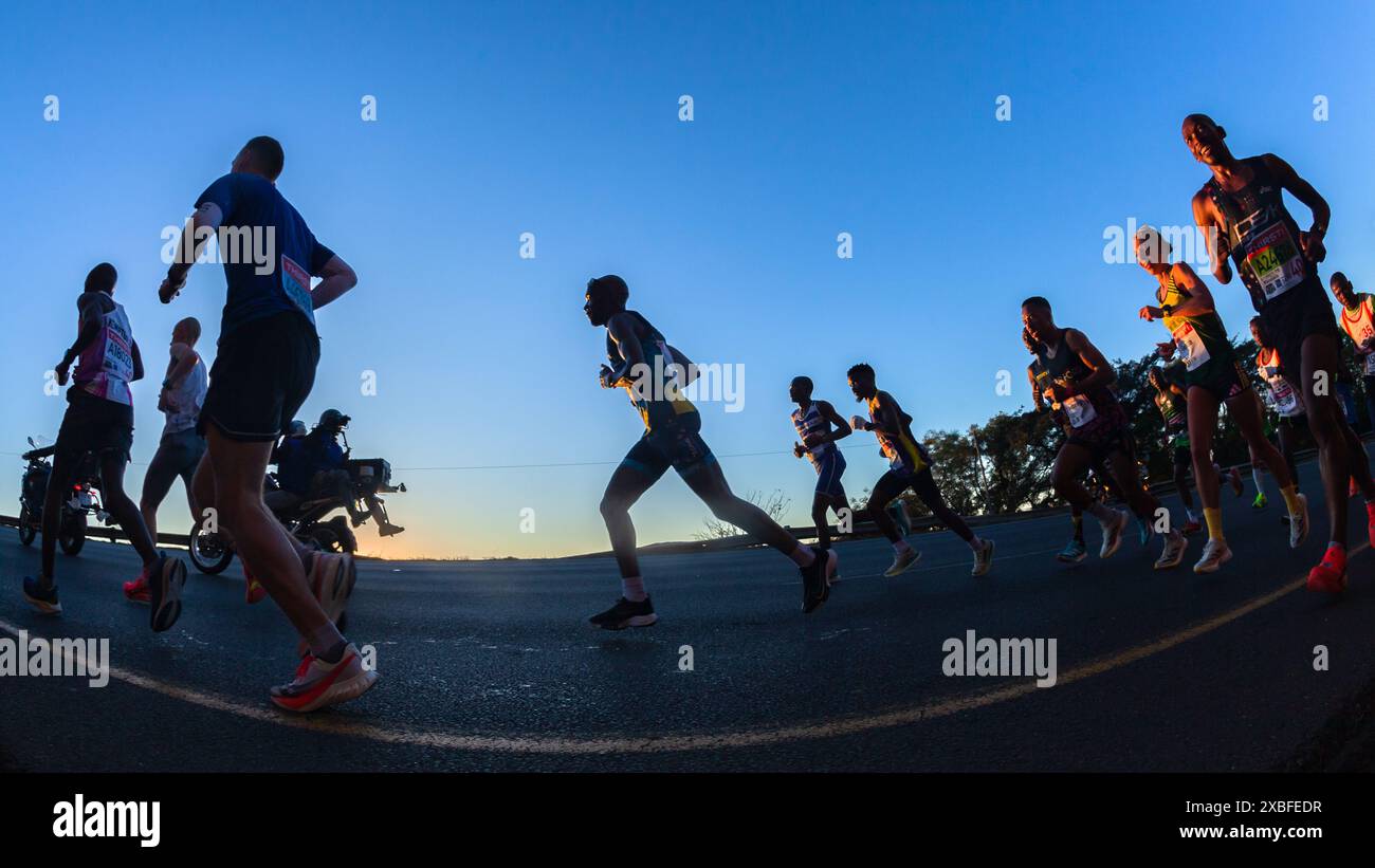 Marathon runners silhouetted morning dawn sunrise running up hill in ...
