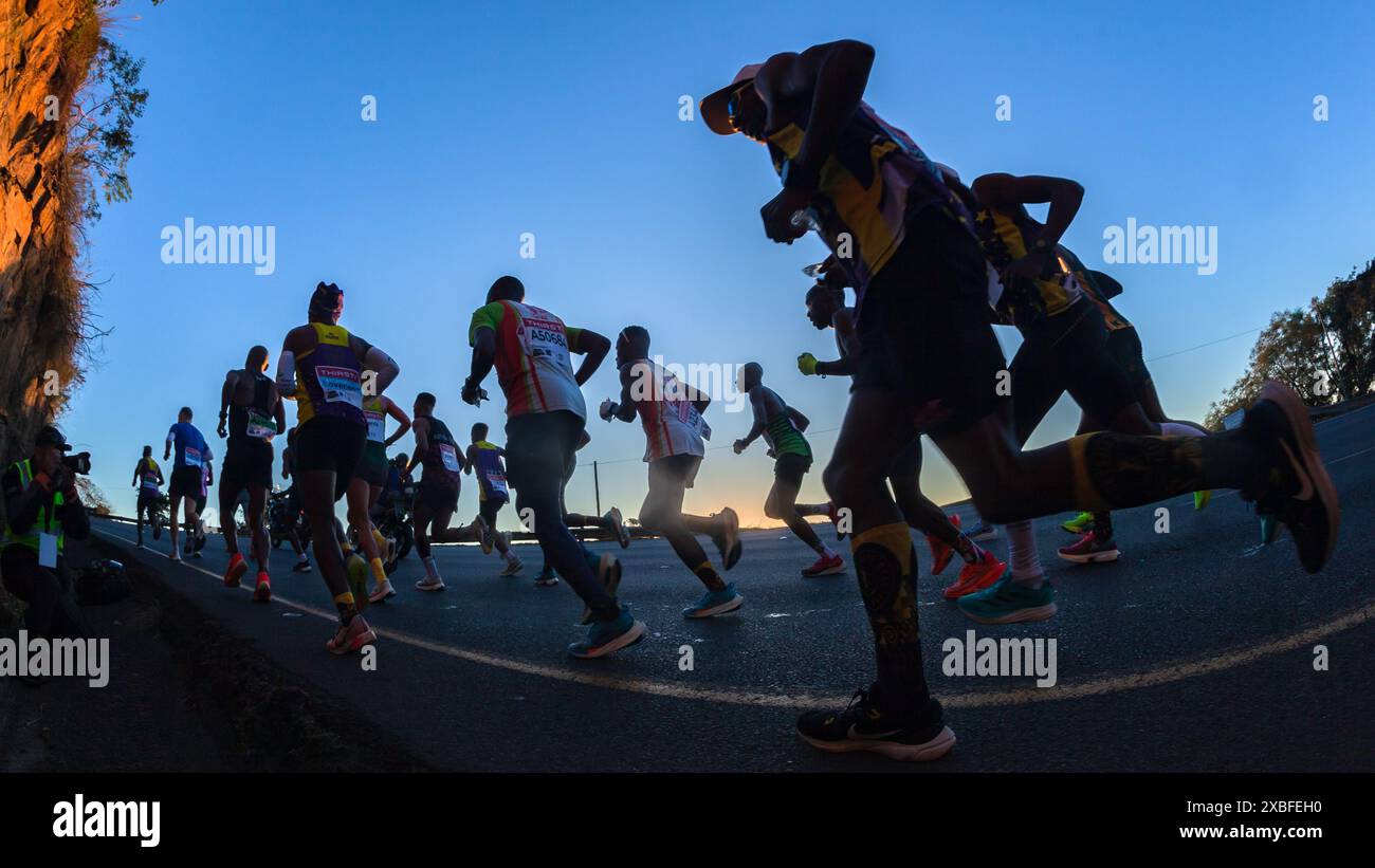 Marathon runners silhouetted morning dawn sunrise running up hill in ...