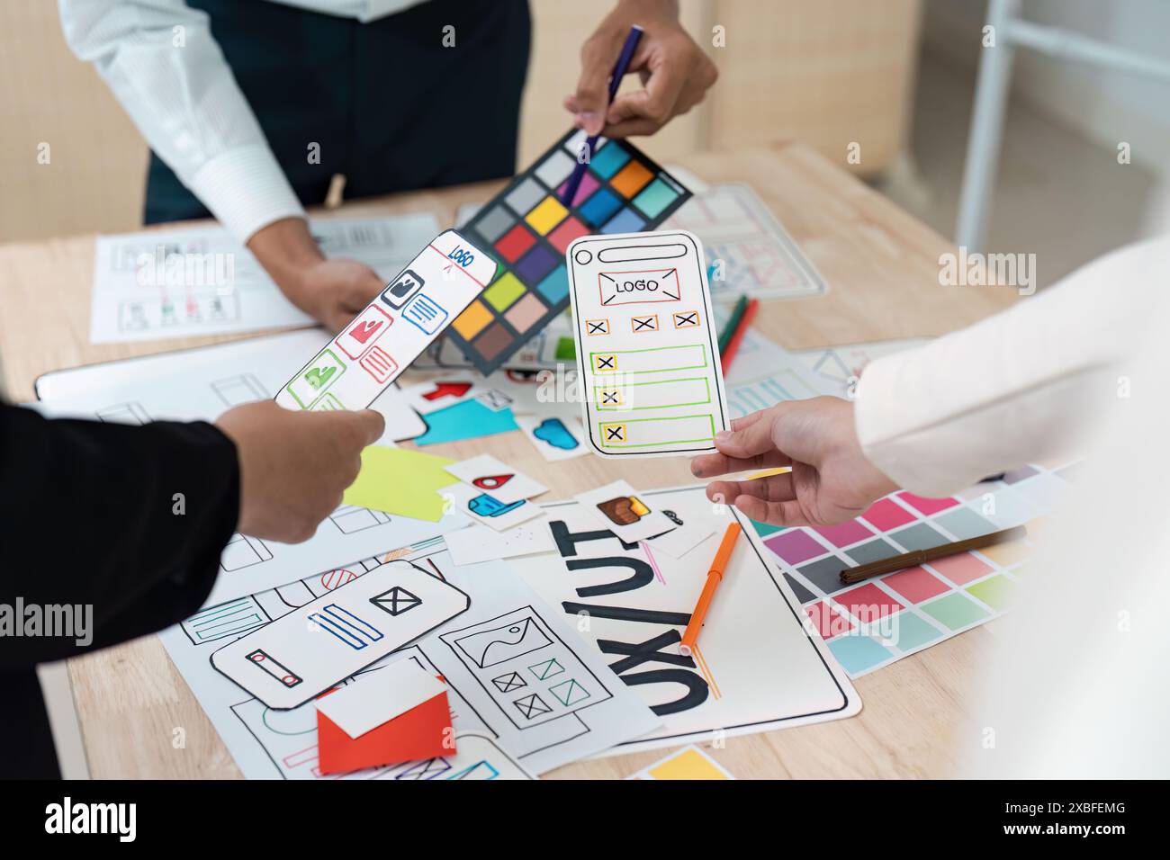 Creative Team Collaboration On Ux Ui Design Concepts With Wireframes And Color Palettes For