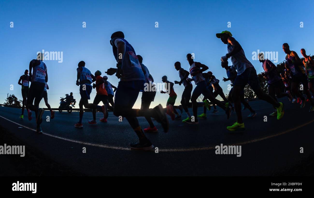 Marathon runners silhouetted morning dawn sunrise running up hill in ...