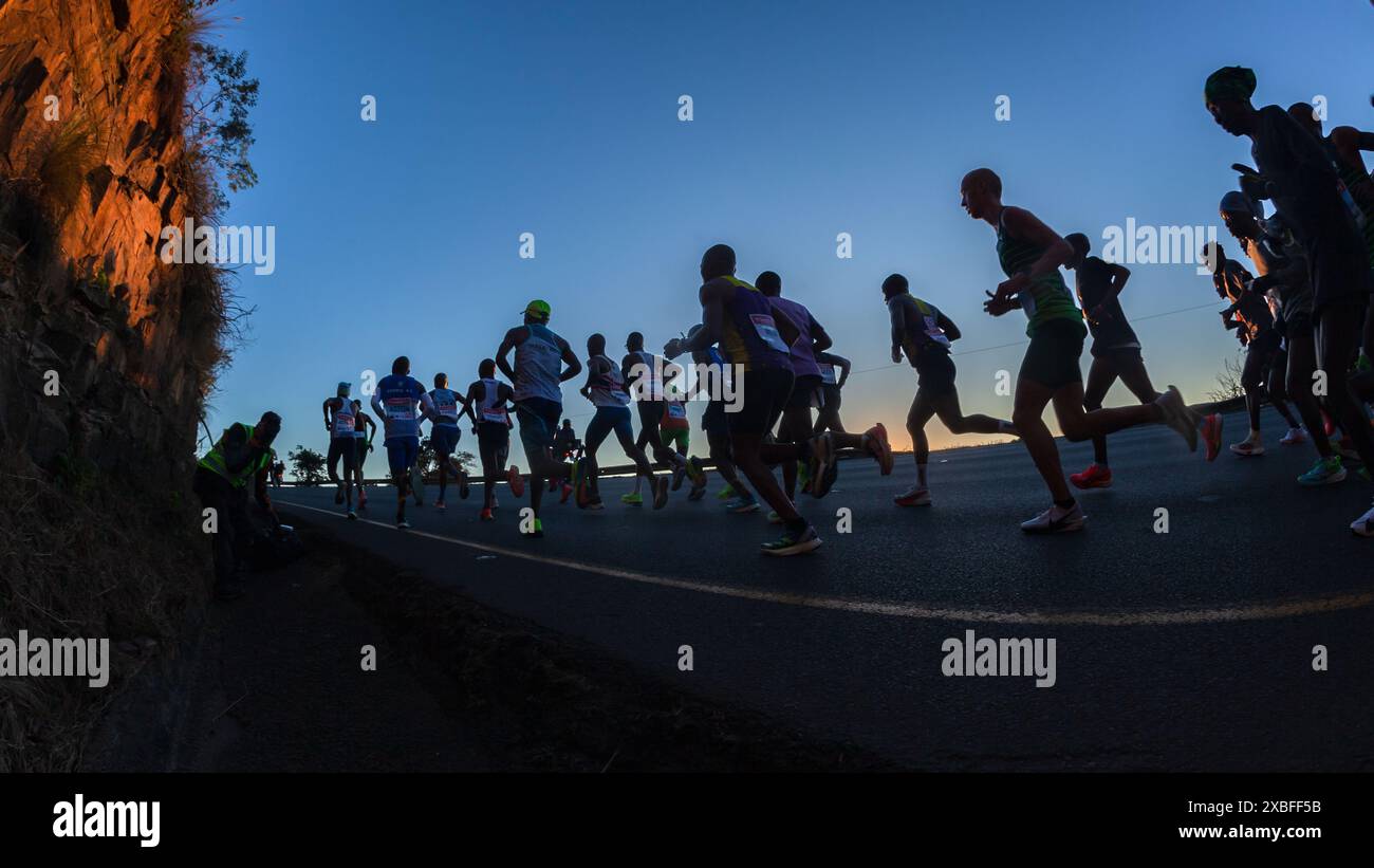Marathon runners silhouetted morning dawn sunrise running up hill in ...