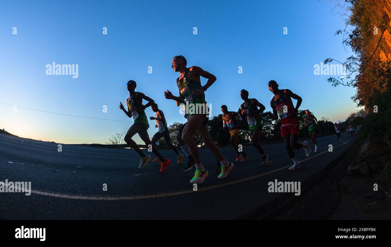 Marathon runners silhouetted morning dawn sunrise running up hill in ...