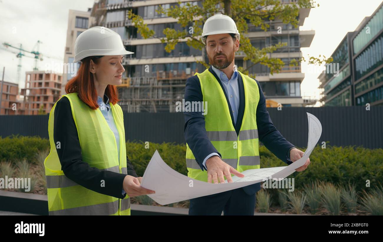 Two contractors civil engineers discuss electrical maintenance ...