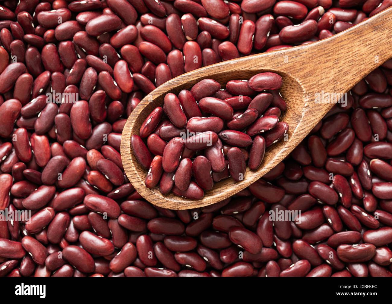 Wooden spoon with red raw organic healthy bean seeds Stock Photo - Alamy