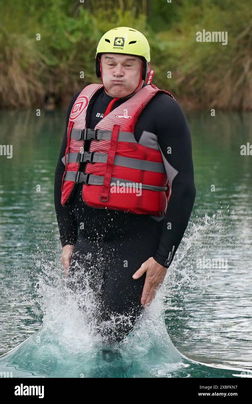 Liberal Democrats leader Sir Ed Davey jumps into the water as he ...