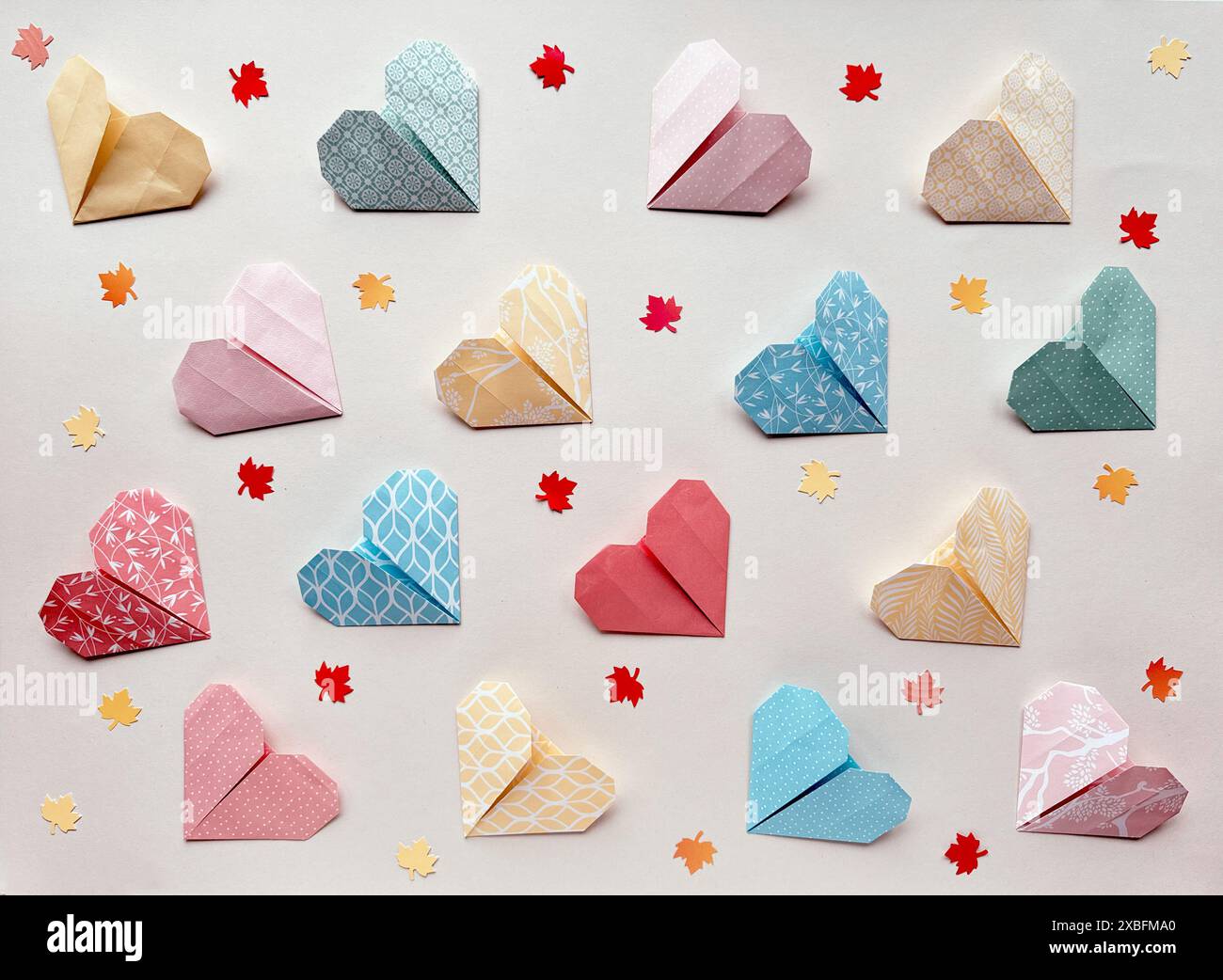 Colorful Origami Hearts Pattern with Small Autumn Leaves on Light ...