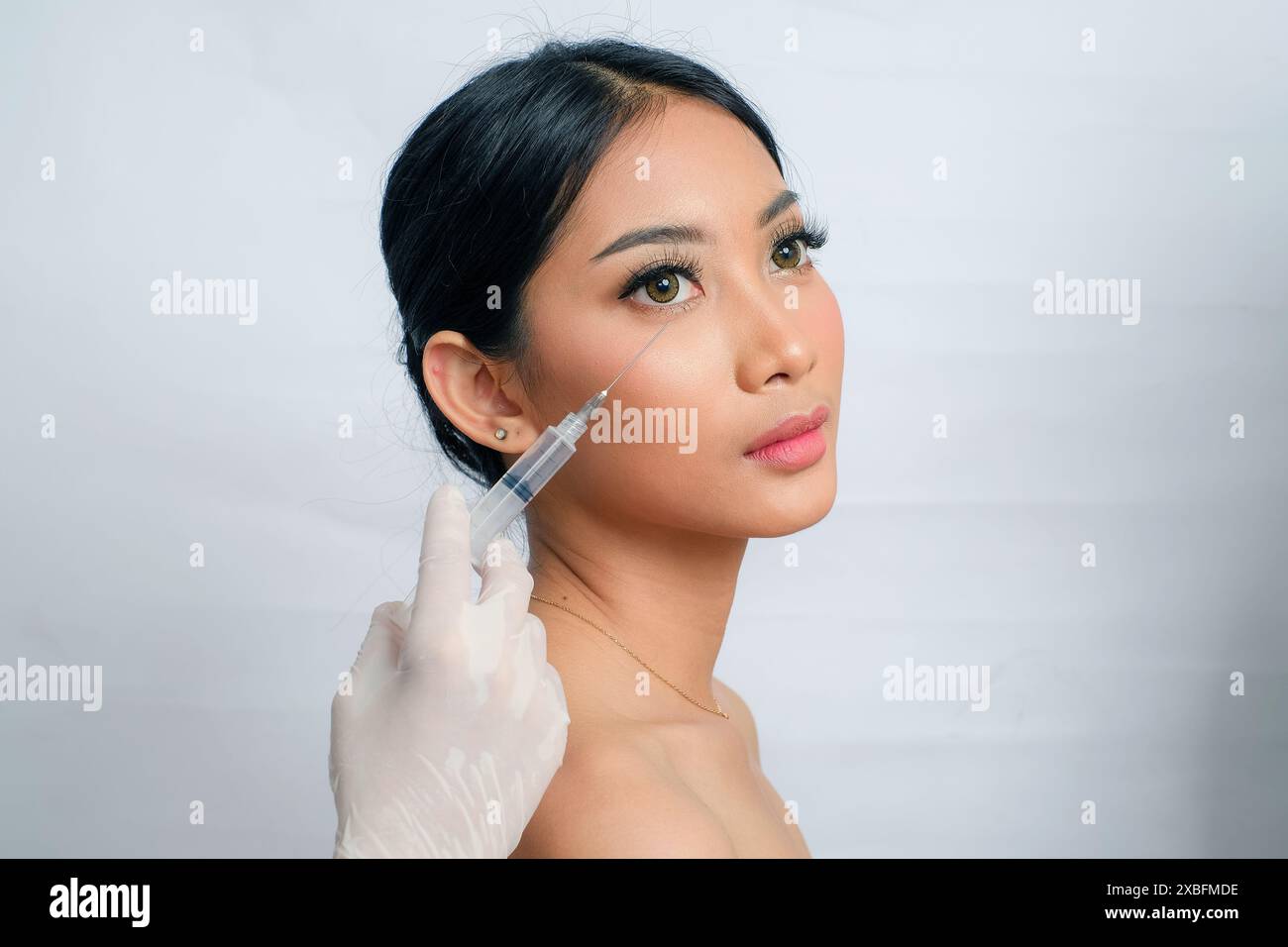 Asian Woman with Hair Bun Receiving Injection for Fat Reduction Stock ...
