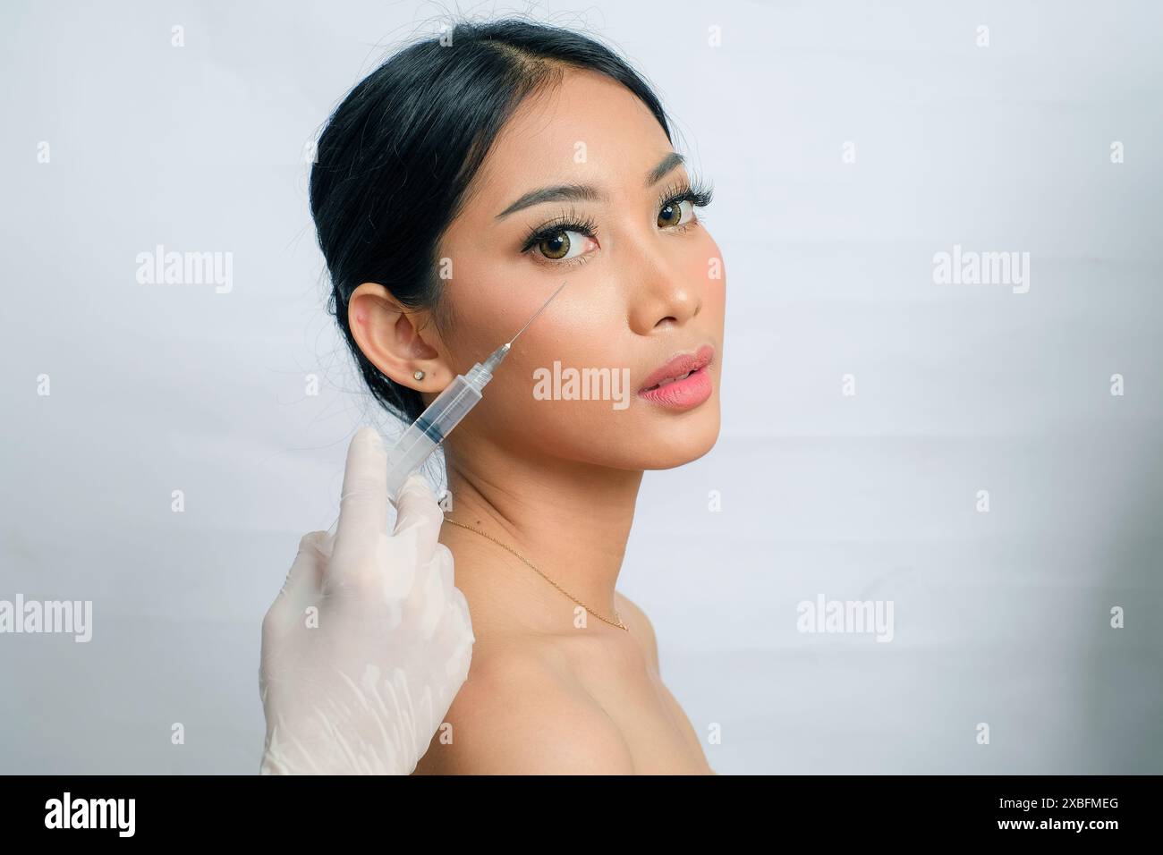 Asian Woman with Neat Bun Receiving Injection to Remove Facial Fat ...