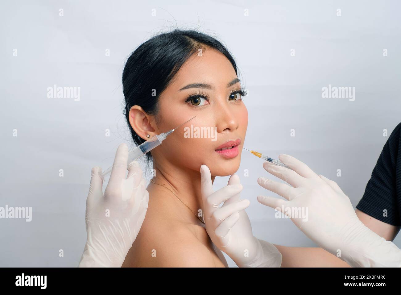 Young Asian Woman with Hair in a Bun Undergoing Fat Removal Injection ...