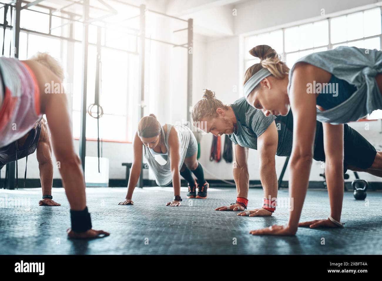 Teamwork, fitness class and exercise with push ups in gym for arm ...