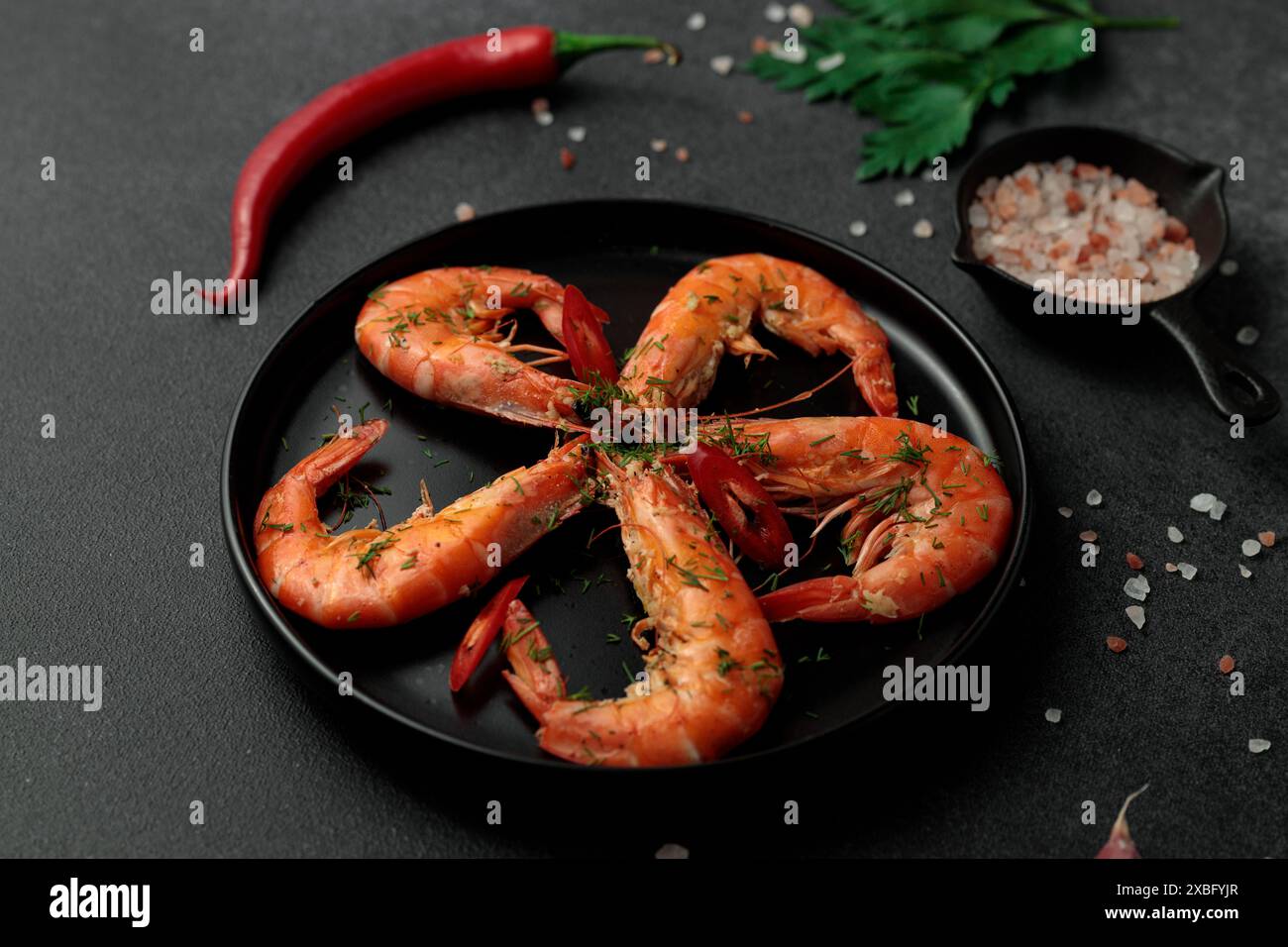 Large cooked king prawns on a black background. Lemon slices Stock ...