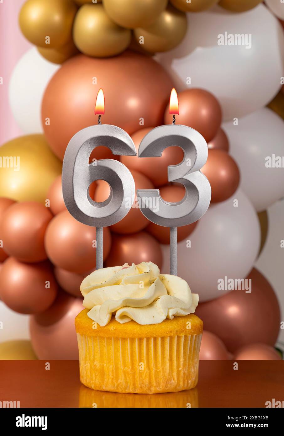 Cupcake with birthday candle on balloons background - Number 63 Stock ...