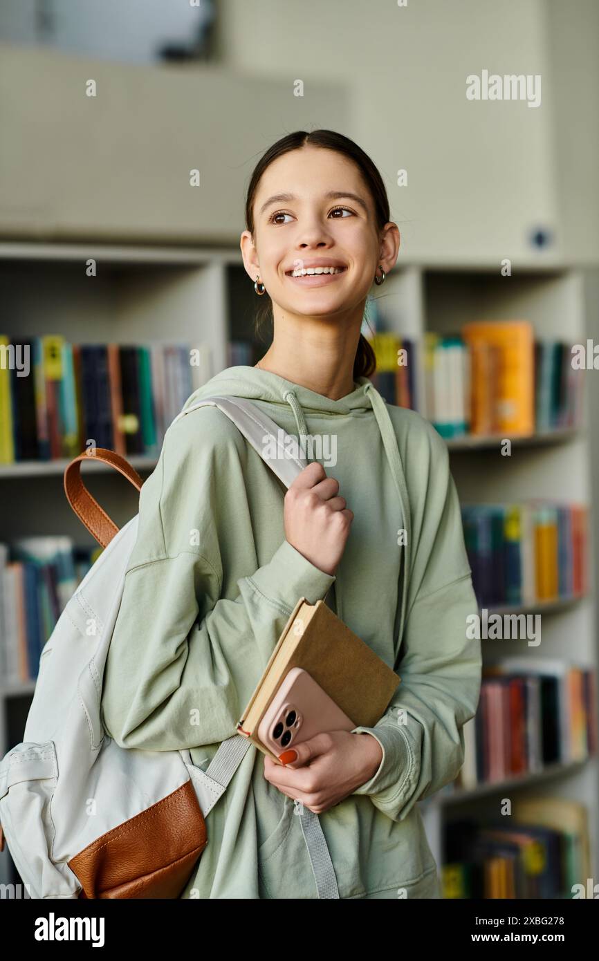 A teenage girl with a backpack full of books explores the library ...