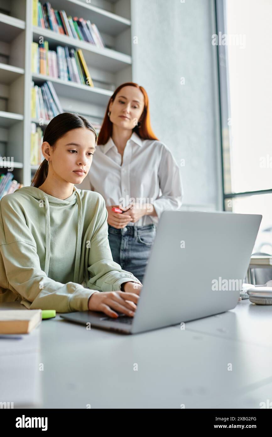 a tutor with red hair and a teenage student, sit at a desk, focused on ...
