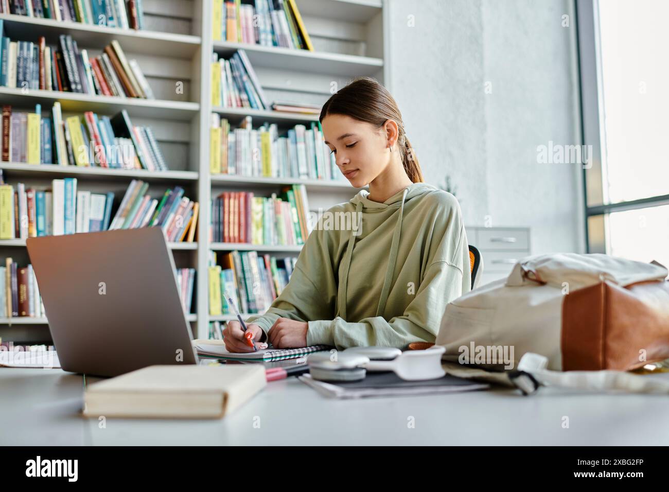 A teenage girl diligently works on her homework at a desk, surrounded ...