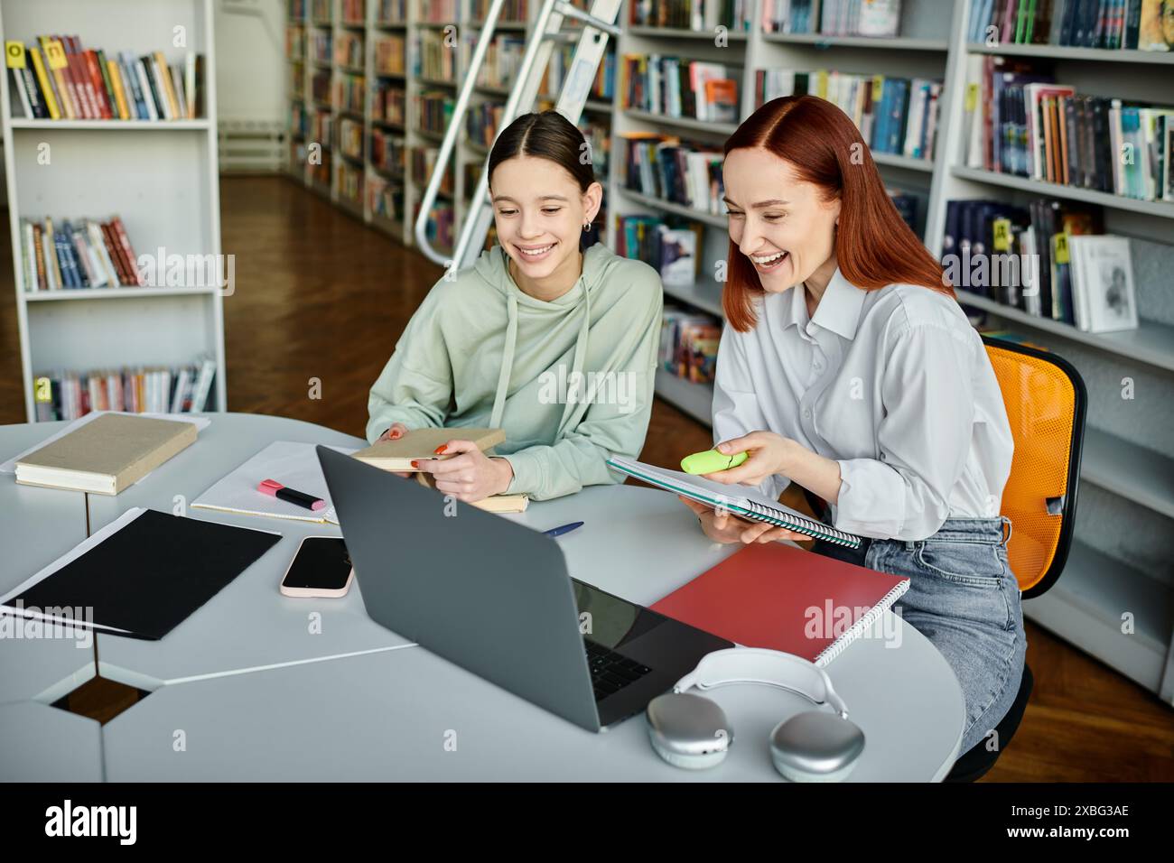 A redhead tutor teaches a teenage girl in a library, engaging in after ...