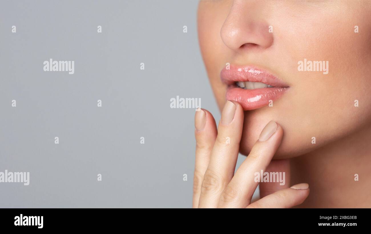 Woman Putting Hand on Lips, Grey Background Stock Photo - Alamy