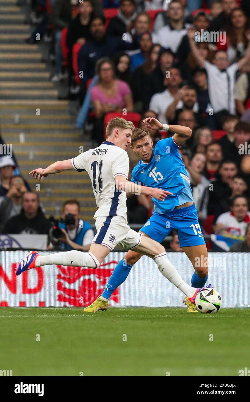 Anthony Gordon of England being closed down by Bjarki Steinn Bjarkason ...