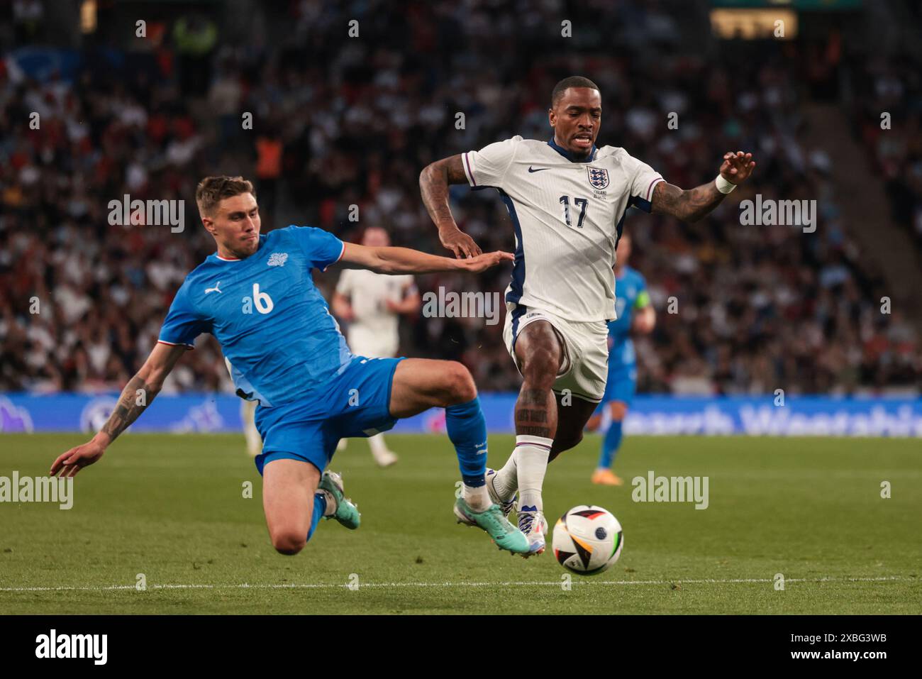 Daniel Leo Gretarsson of Iceland tackling Ivan Toney of England in the ...