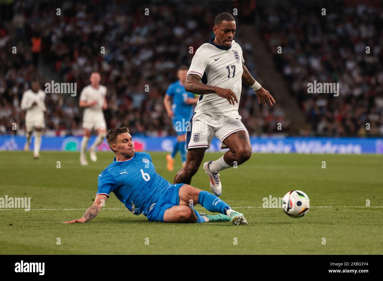 Daniel Leo Gretarsson of Iceland tackling Ivan Toney of England in the ...