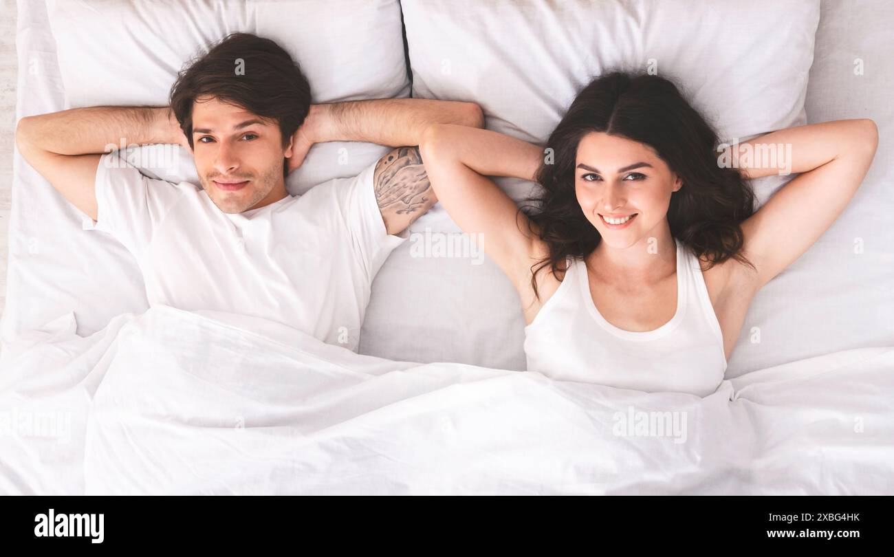 Couple Relaxing In Bed Together After Waking Up Stock Photo - Alamy