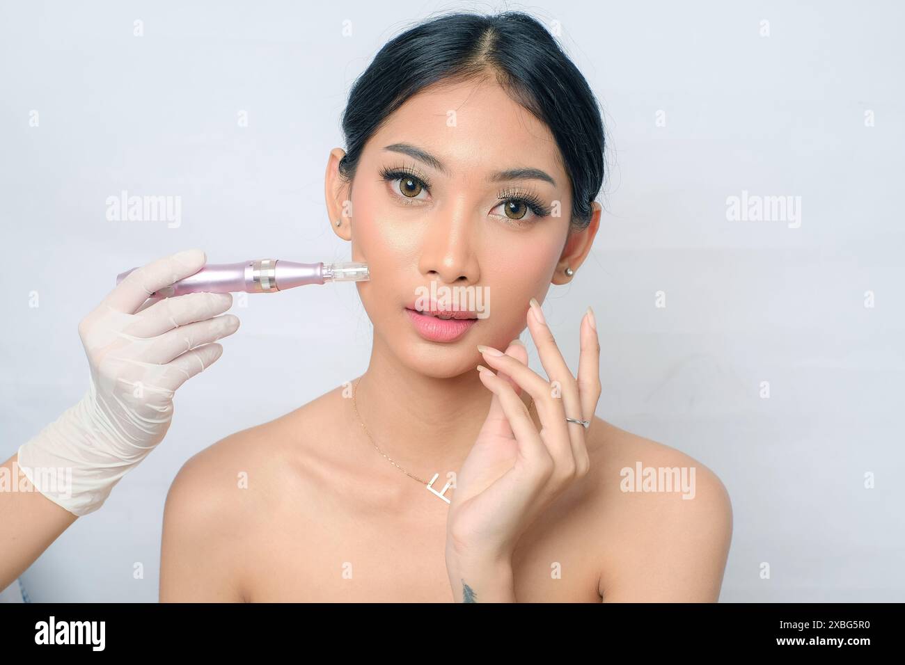 Charming Asian Woman Performing Beauty Treatment with Dermatology Pen ...