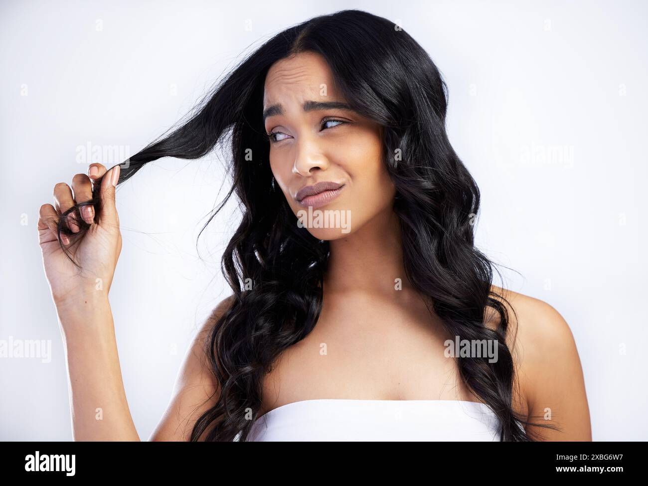 Woman, worried and hair beauty in studio with messy, damage and texture ...