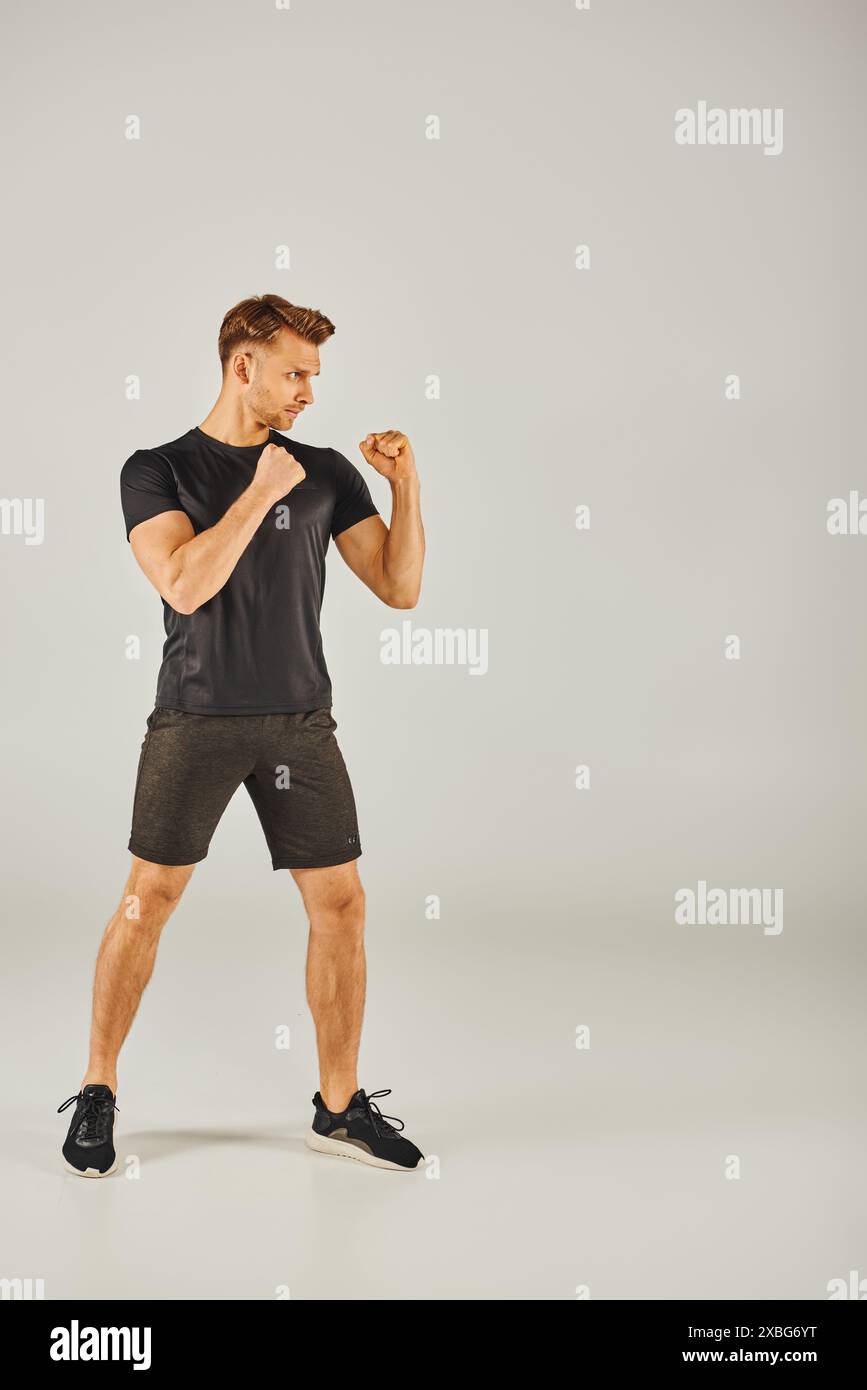A young man confidently posing against a white background in a stylish ...