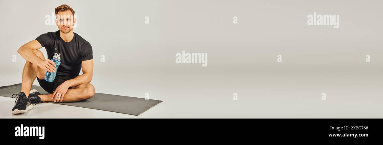 A young sportsman in active wear focuses on perfecting his squat ...